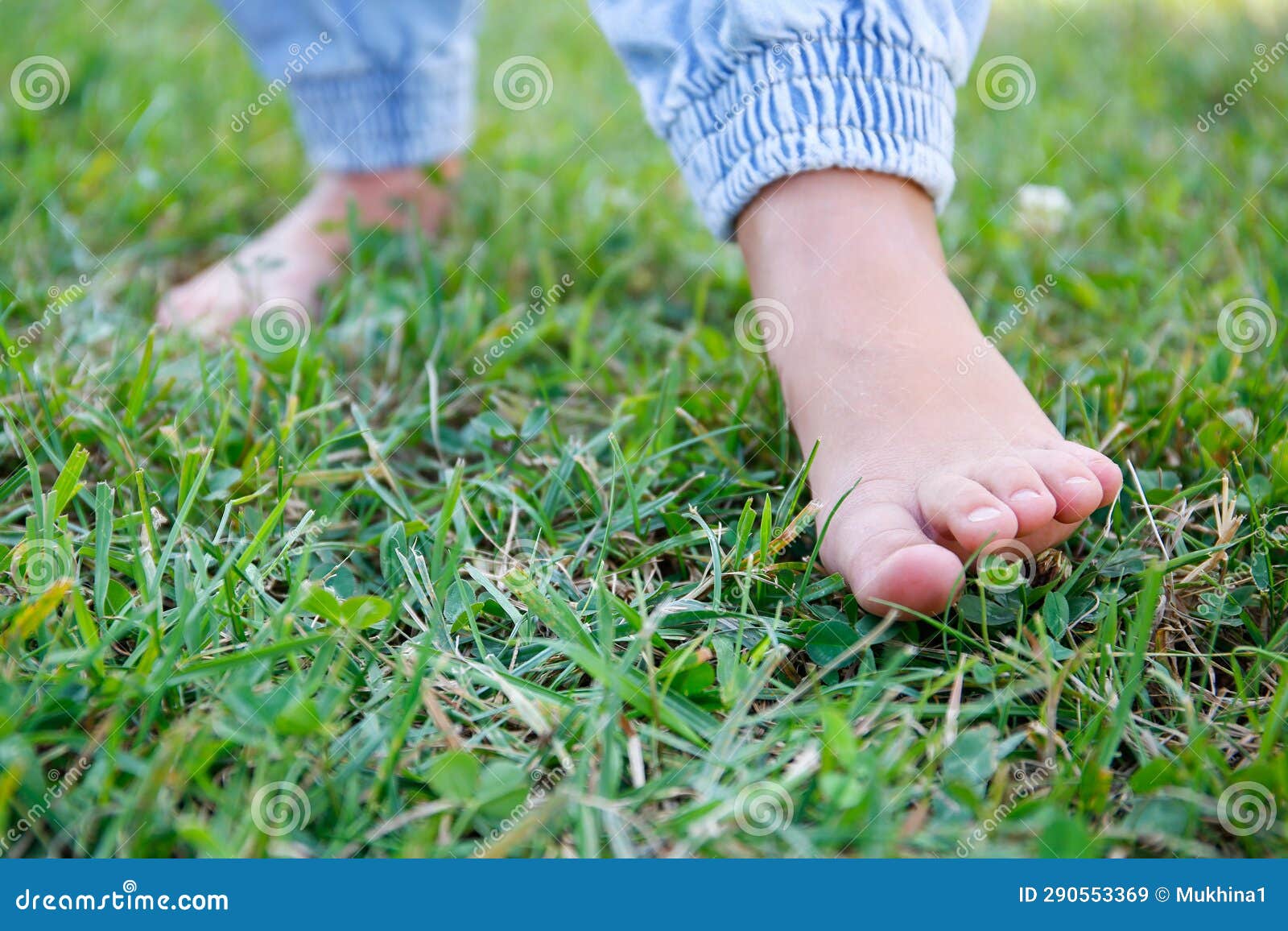 The Child Walks Barefoot on the Grass Stock Image - Image of barefoot ...