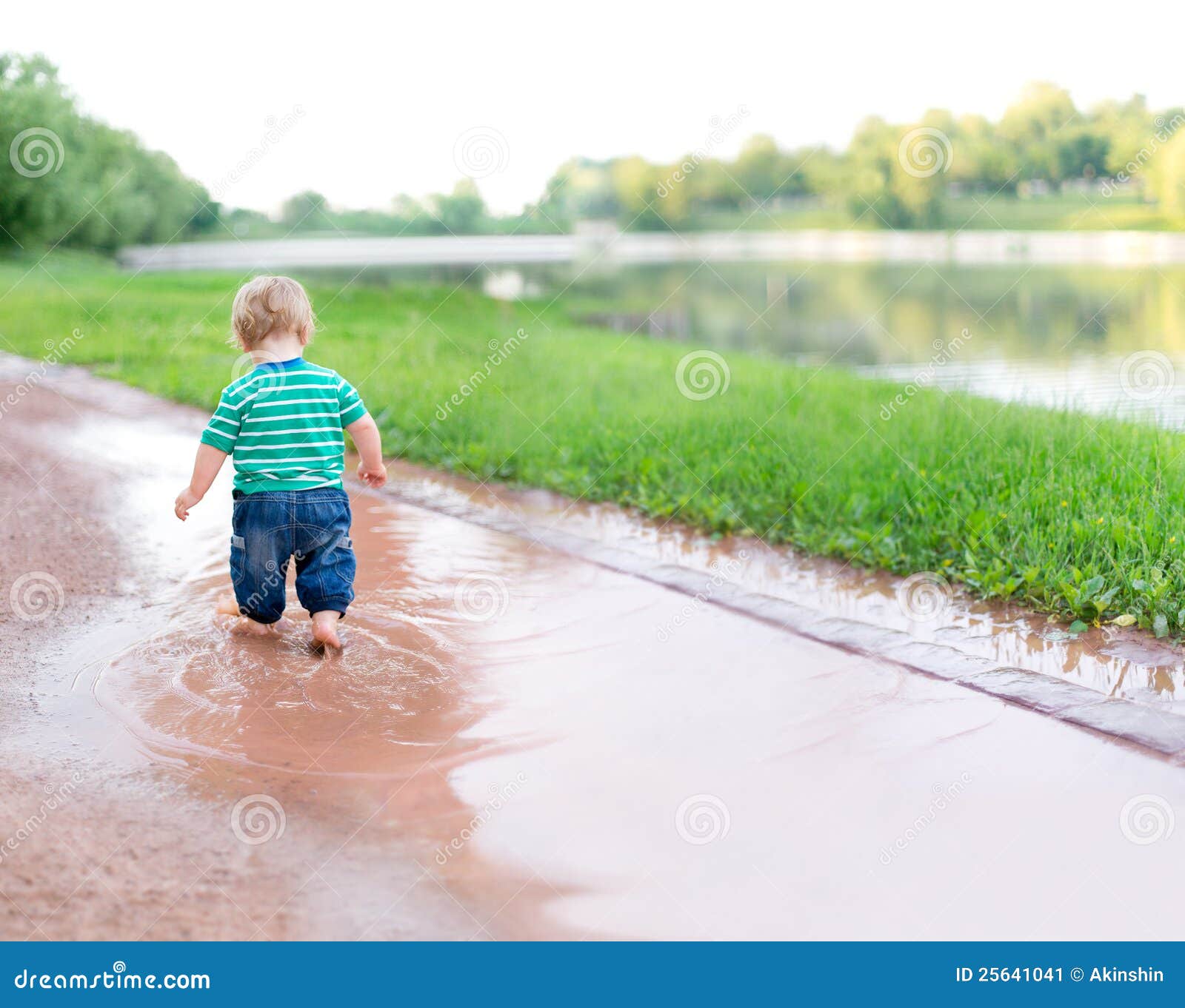 Child walks on the puddles stock image. Image of explore - 25641041