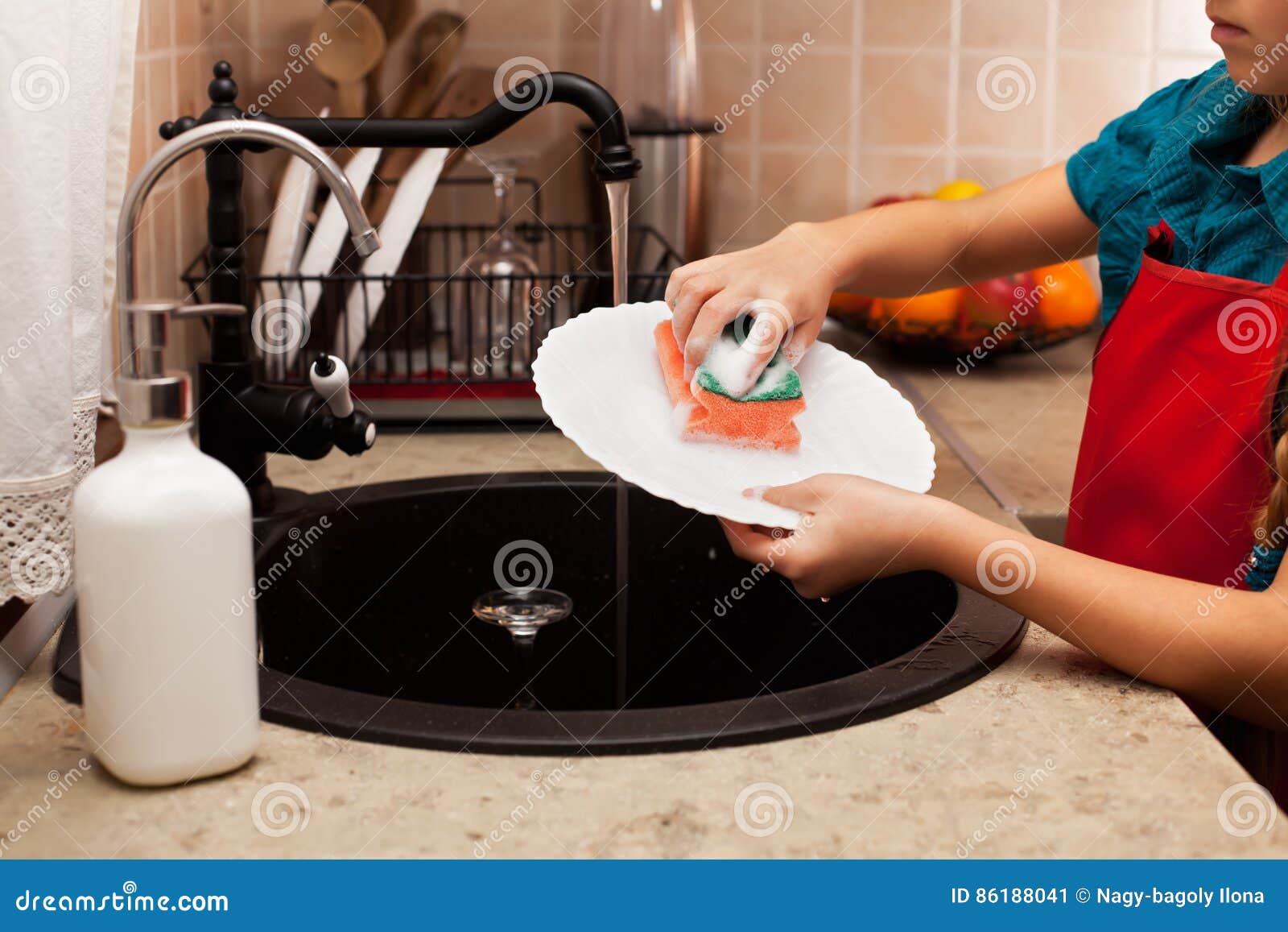 Child Washing a Plate with Sponge at the Kitchen Sink, Shallow D Stock ...
