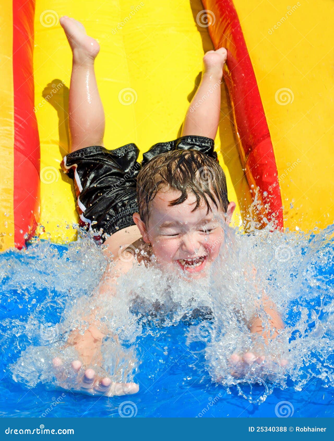 Child on water slide stock photo. Image of activity, waterslide - 25340388