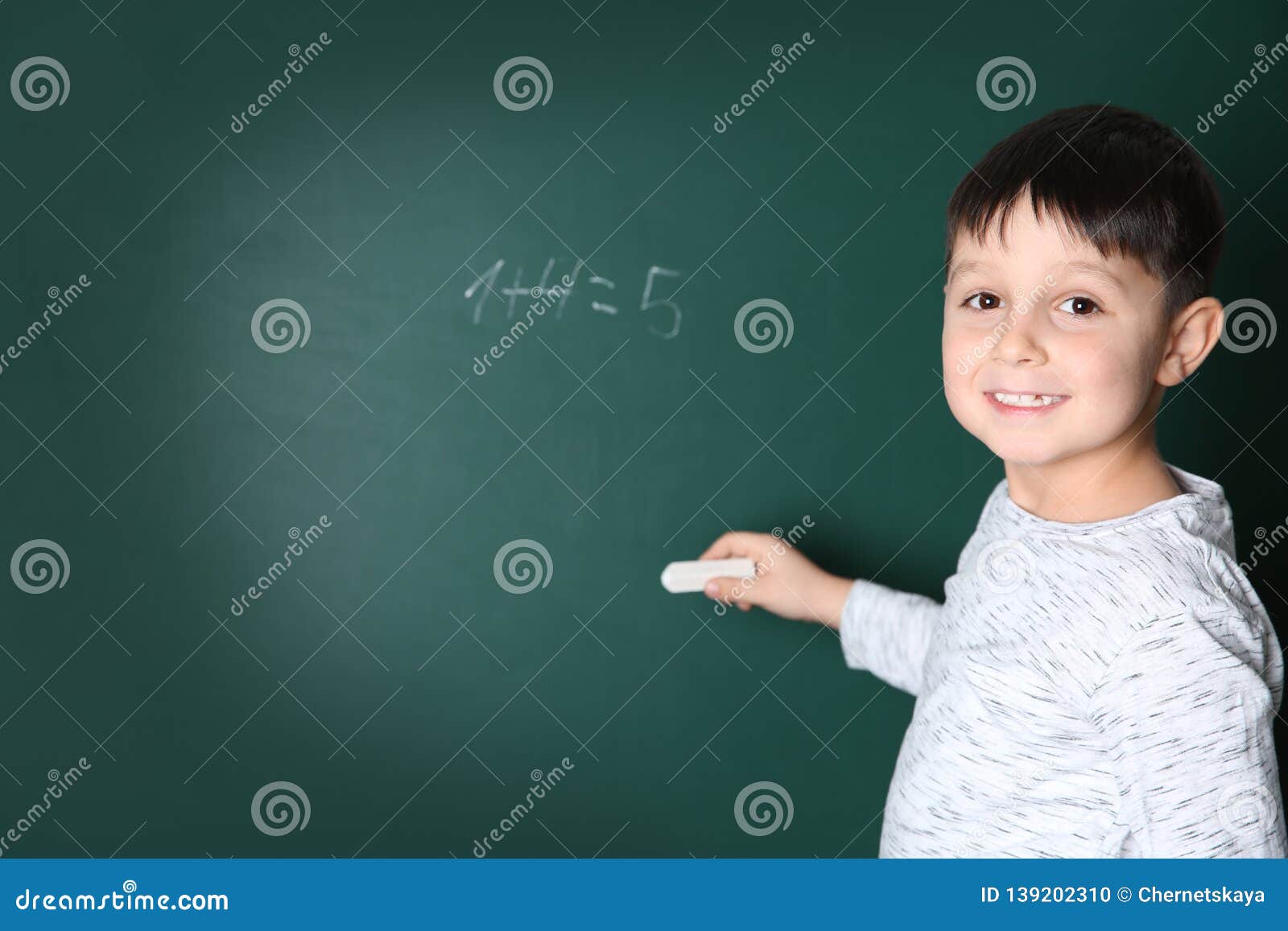 Child Writing Math Sum on Chalkboard. Stock Photo - Image of little ...