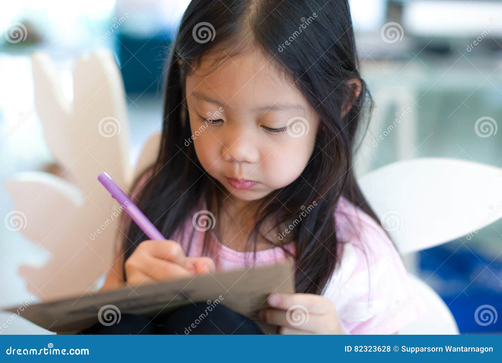 Child Writing on Notebook stock photo. Image of child - 82323628