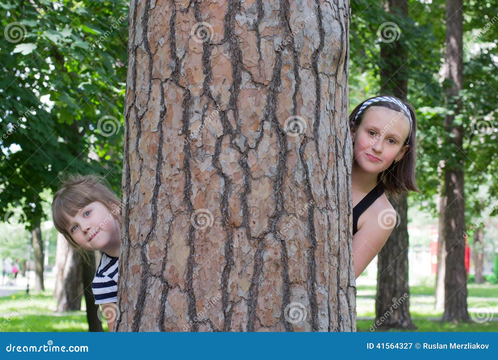 Children behind a tree stock image. Image of family, grass - 41564327