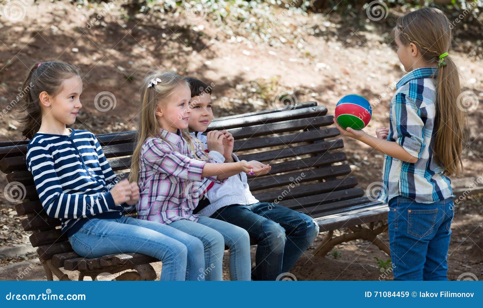 Children on the Bench Playing with Ball Stock Image - Image of group ...