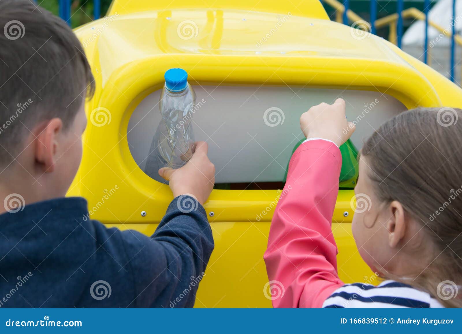 Children, a Boy and a Girl, Throw Empty Plastic Bottles into a Garbage ...