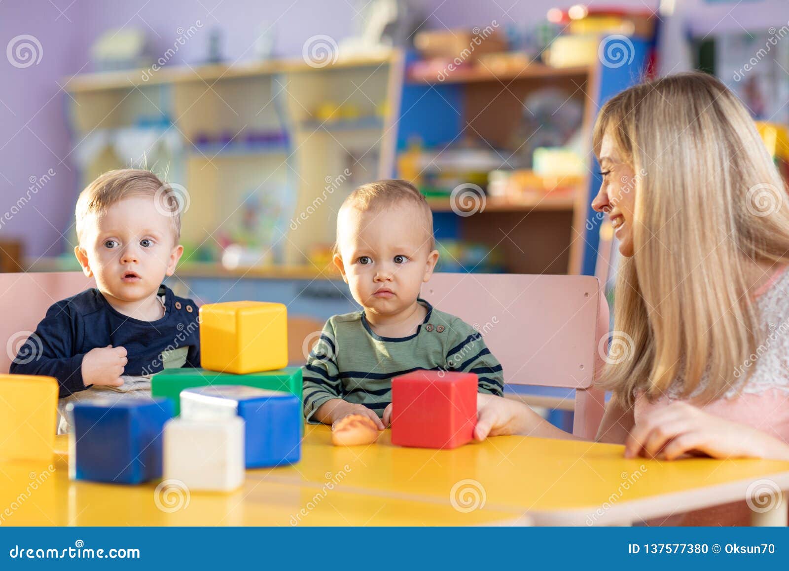 Children Building Blocks with a Teacher in the Nursery Stock Photo ...