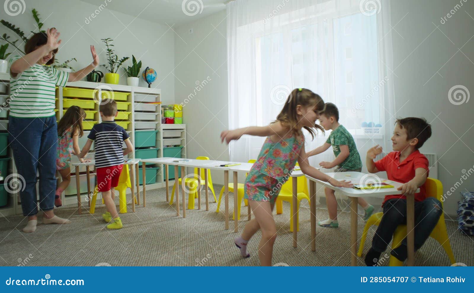 Children Cheerfully Run into the Classroom and Wave To the Teacher ...