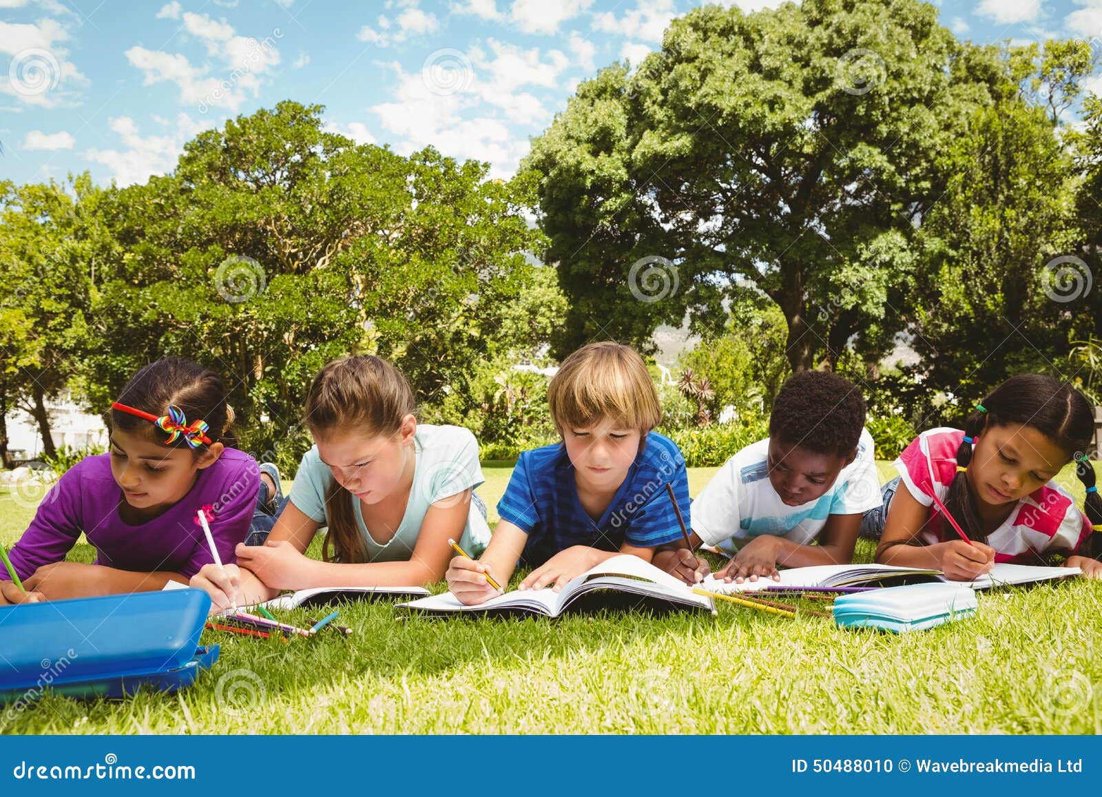 Children Doing Homework at Park Stock Photo - Image of girl, grass ...