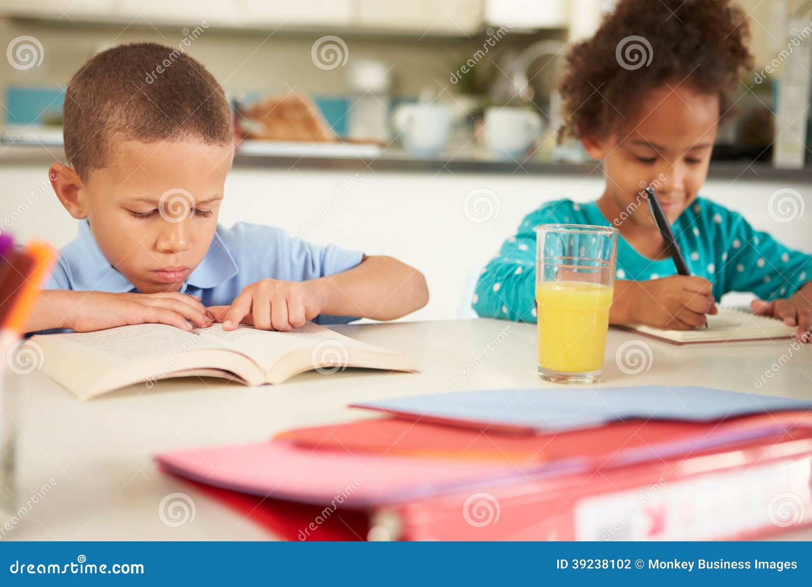 Children Doing Homework Together at Table Stock Photo - Image of book ...