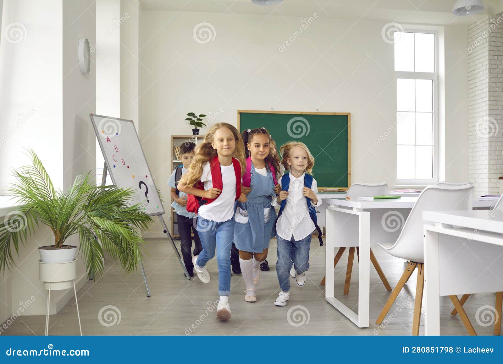 Children Dressed in Backpacks with Textbooks Joyfully Run Out of ...