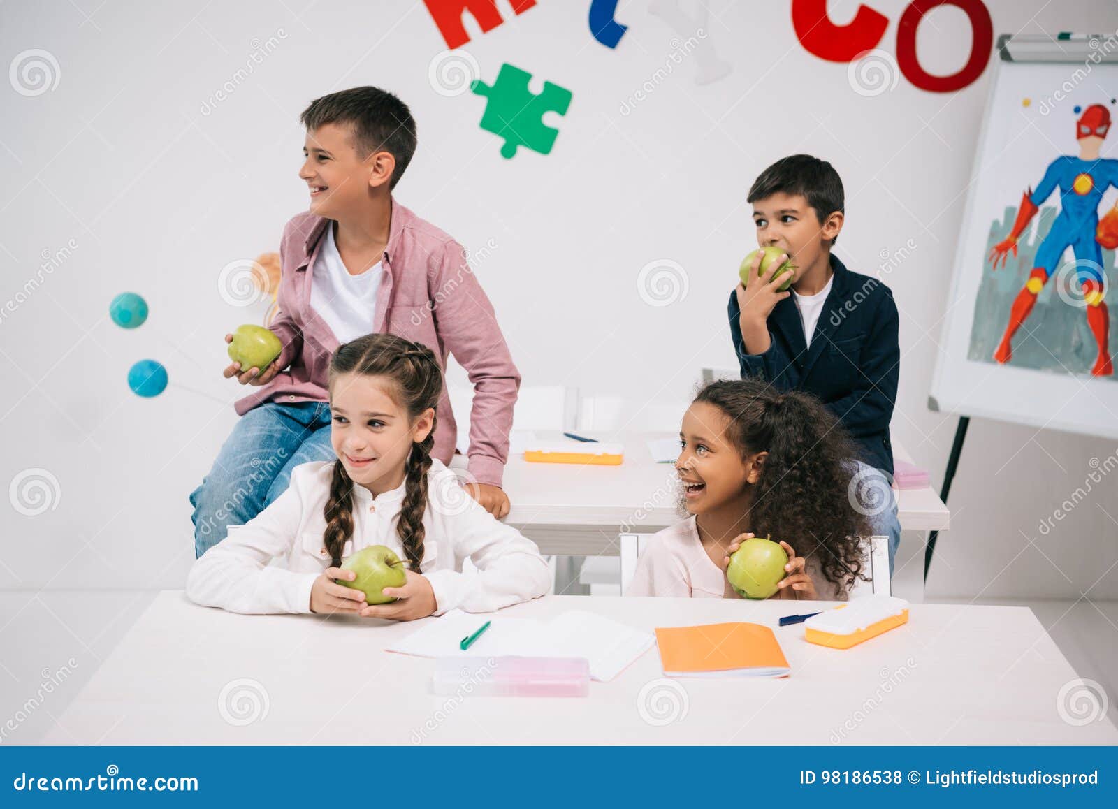 Children Eating Apples while Sitting in Classroom during Break Stock ...
