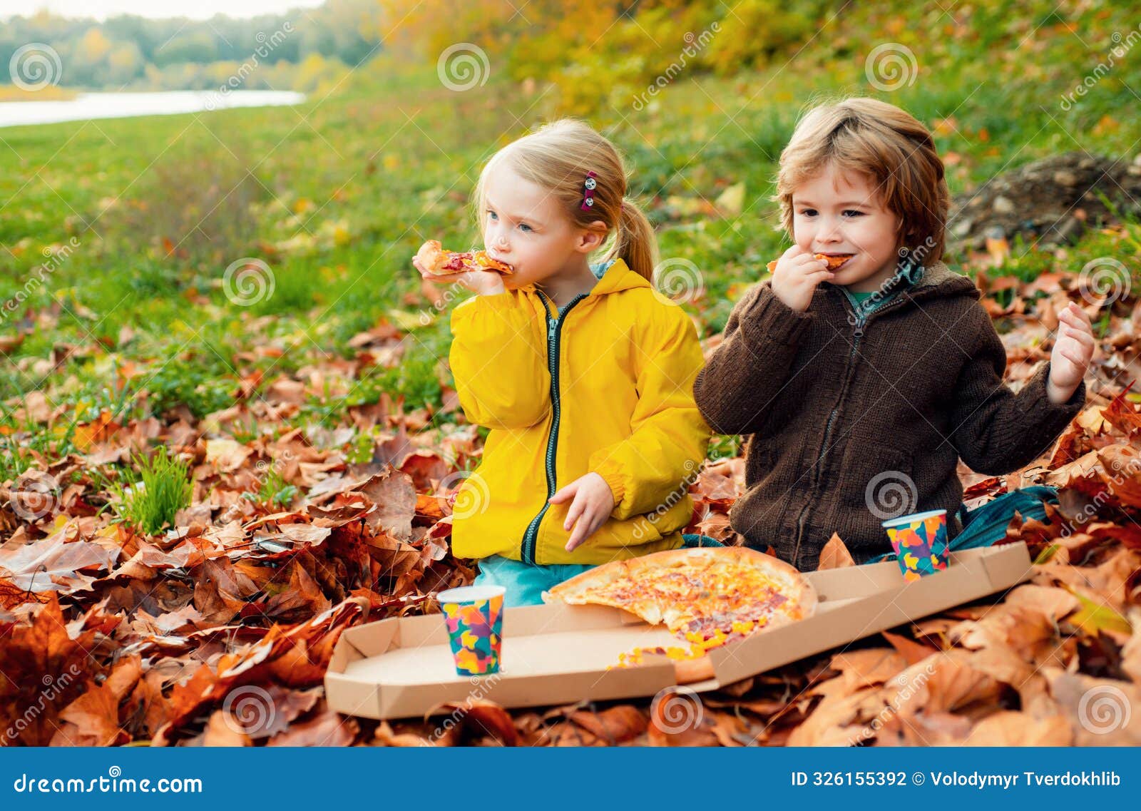 Children Eating Pizza on Autumn Fall Time in Nature. Stock Photo ...