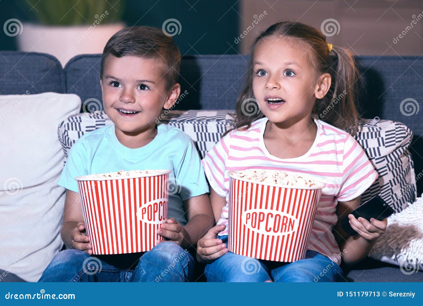 Children Eating Popcorn while Watching TV in Evening Stock Image ...