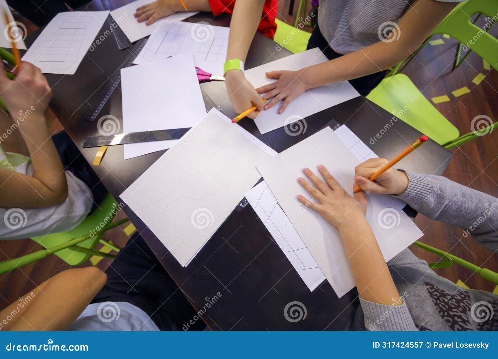 Children Encircle Hand with a Pencil on a Sheet of Stock Image - Image ...