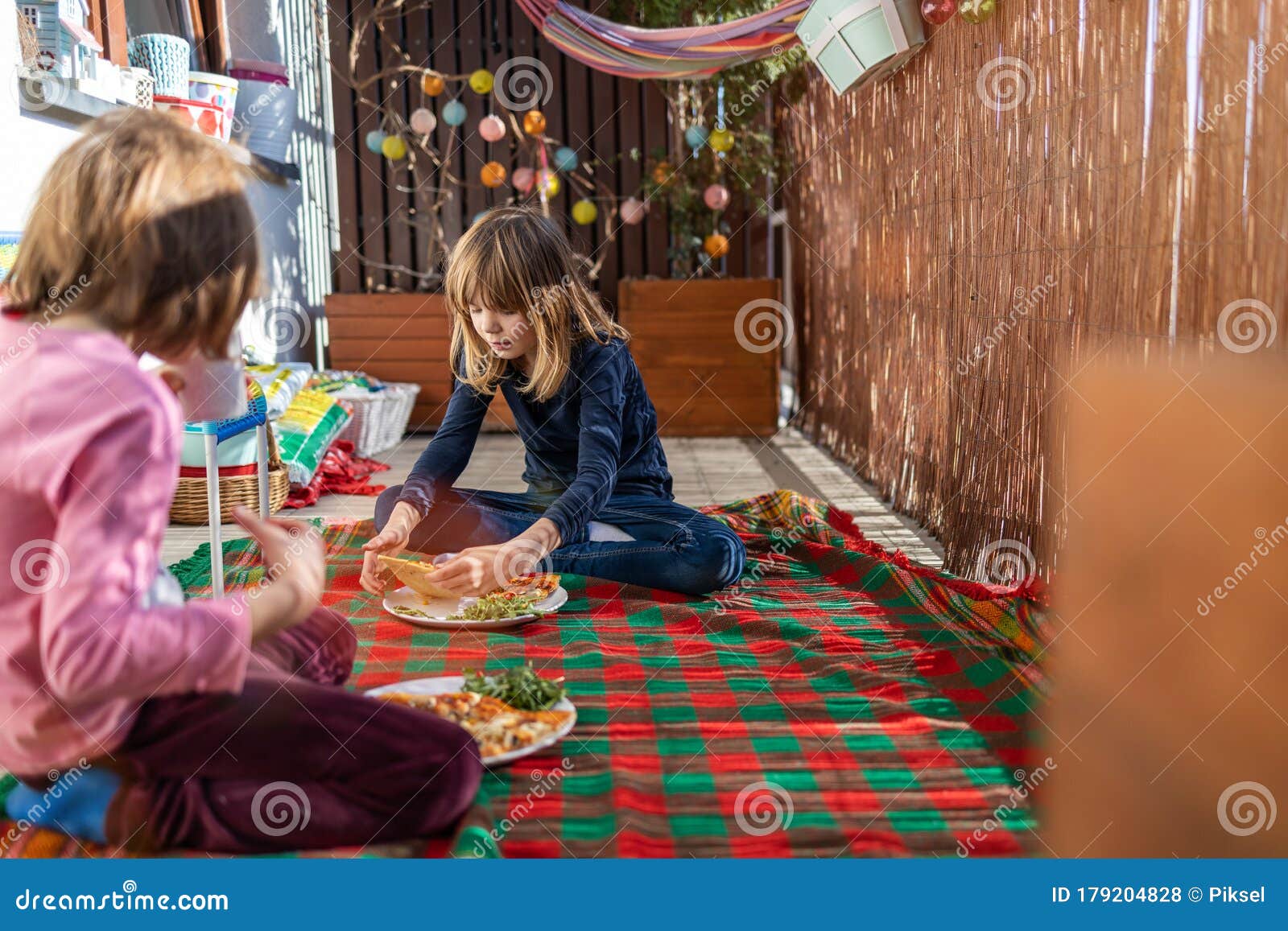 Children Enjoying Pizza on a Balcony Stock Photo - Image of pizza ...