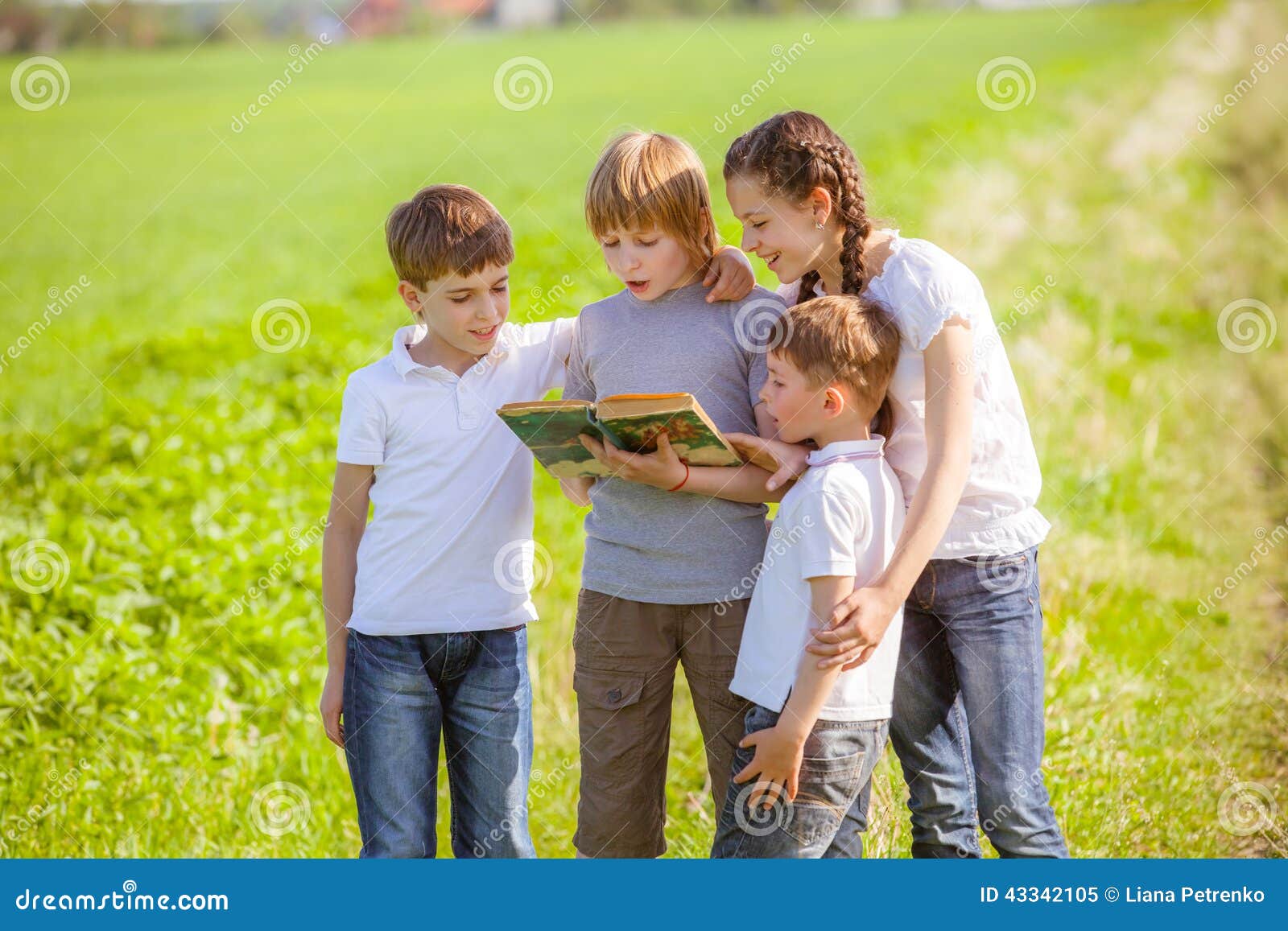 Children enjoying reading stock image. Image of field - 43342105