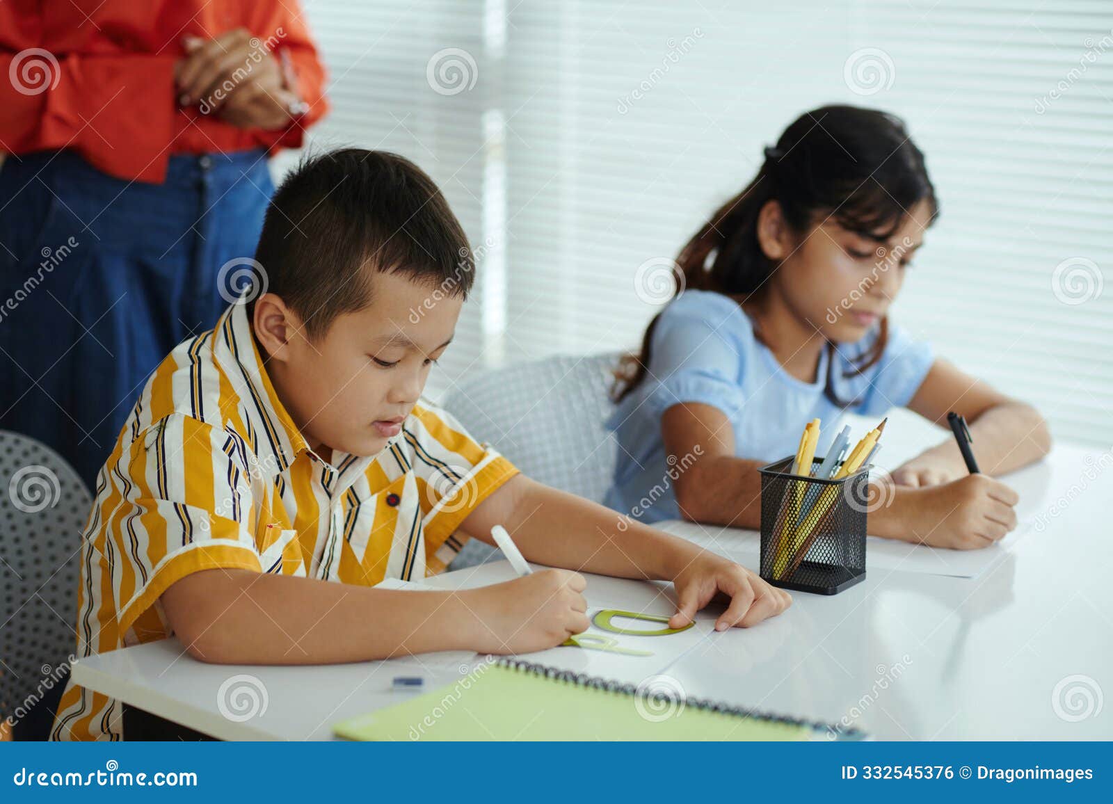 Children Focusing on Classroom Writing Activity Stock Photo - Image of ...
