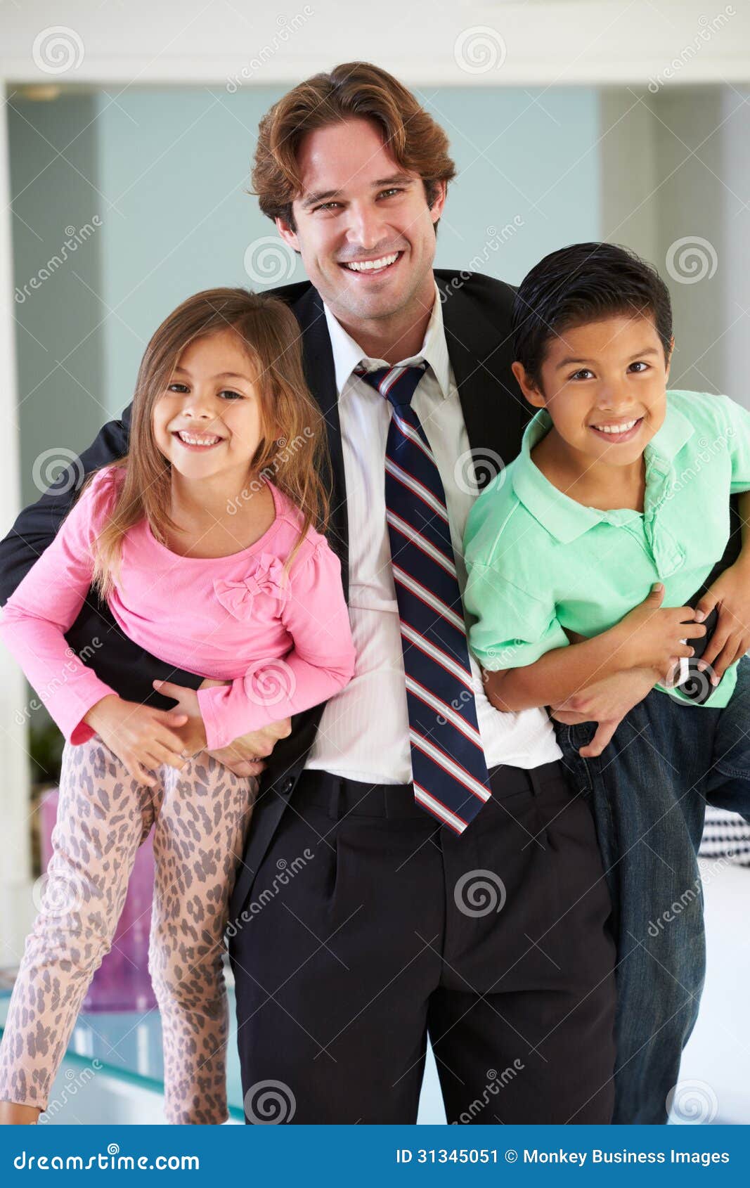 Children Greeting And Hugging Working Businessman Father As He Returns ...