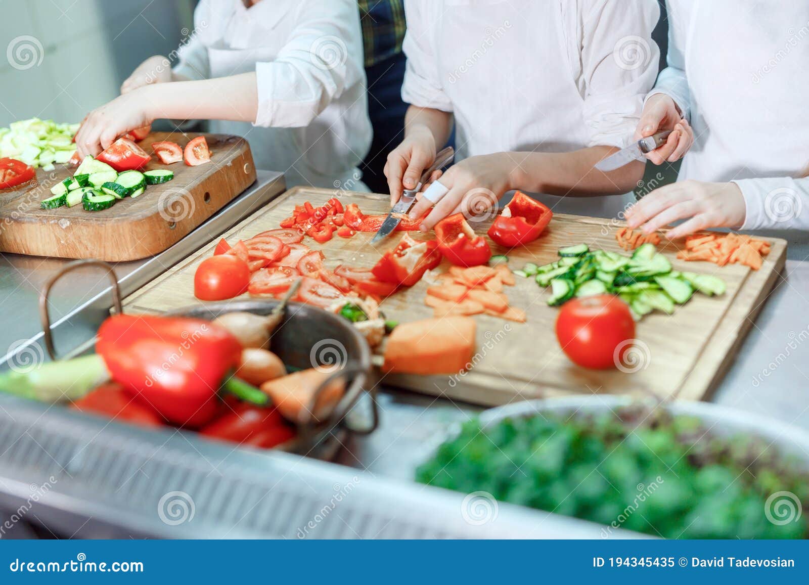 Children Grind Vegetables in the Kitchen of a Restaurant. Stock Image ...