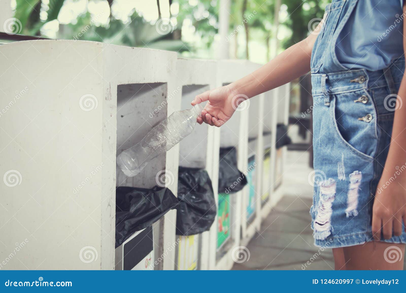 Children Hand Throwing Empty Plastic Bottle into the Trash Recycling at ...