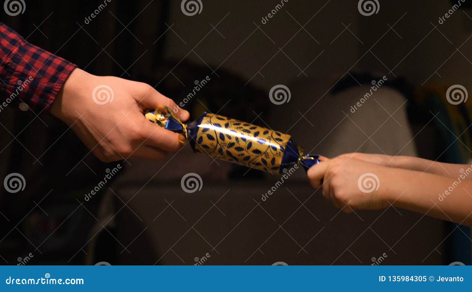 Children Hands Holding and Pulling Christmas Cracker at Home Stock ...