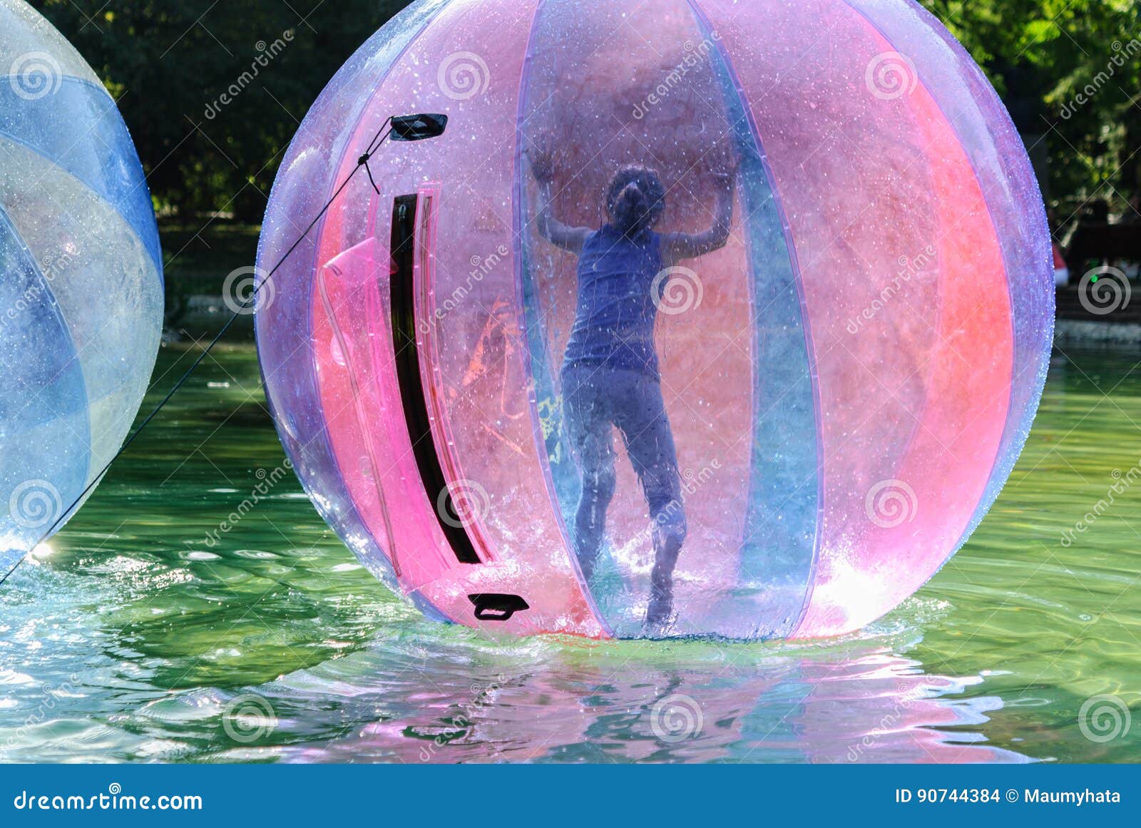 Children Have Fun Inside Plastic Balloons On The Water. Stock Photo ...