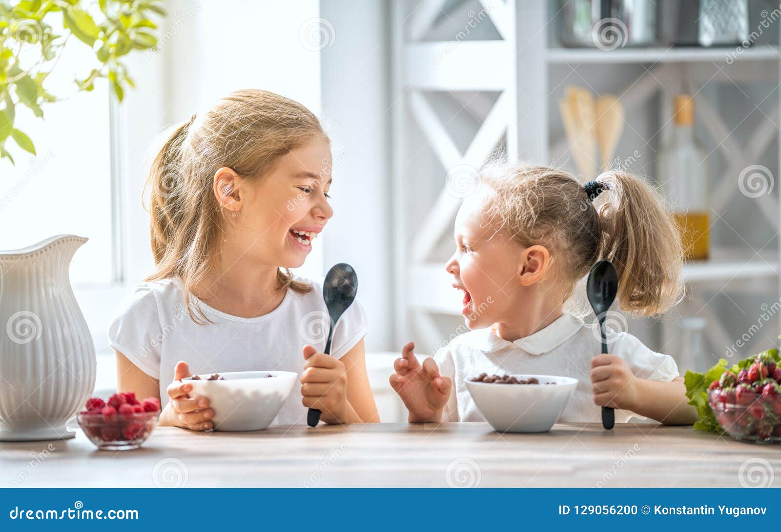 Children having breakfast stock photo. Image of bowl - 129056200