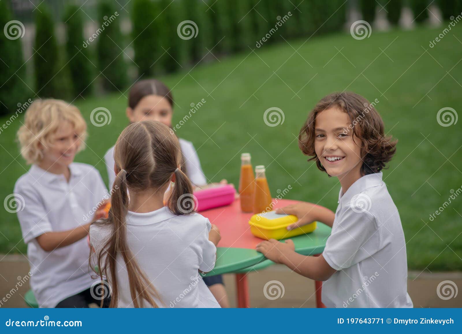 Children Having Lunch Together and Looking Cheerful Stock Image - Image ...