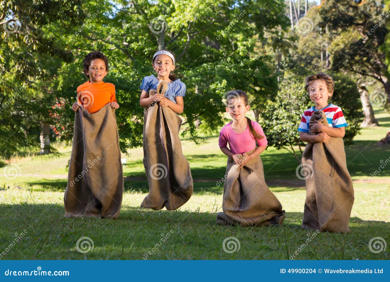 Children Having a Sack Race in Park Stock Photo - Image of jumping ...