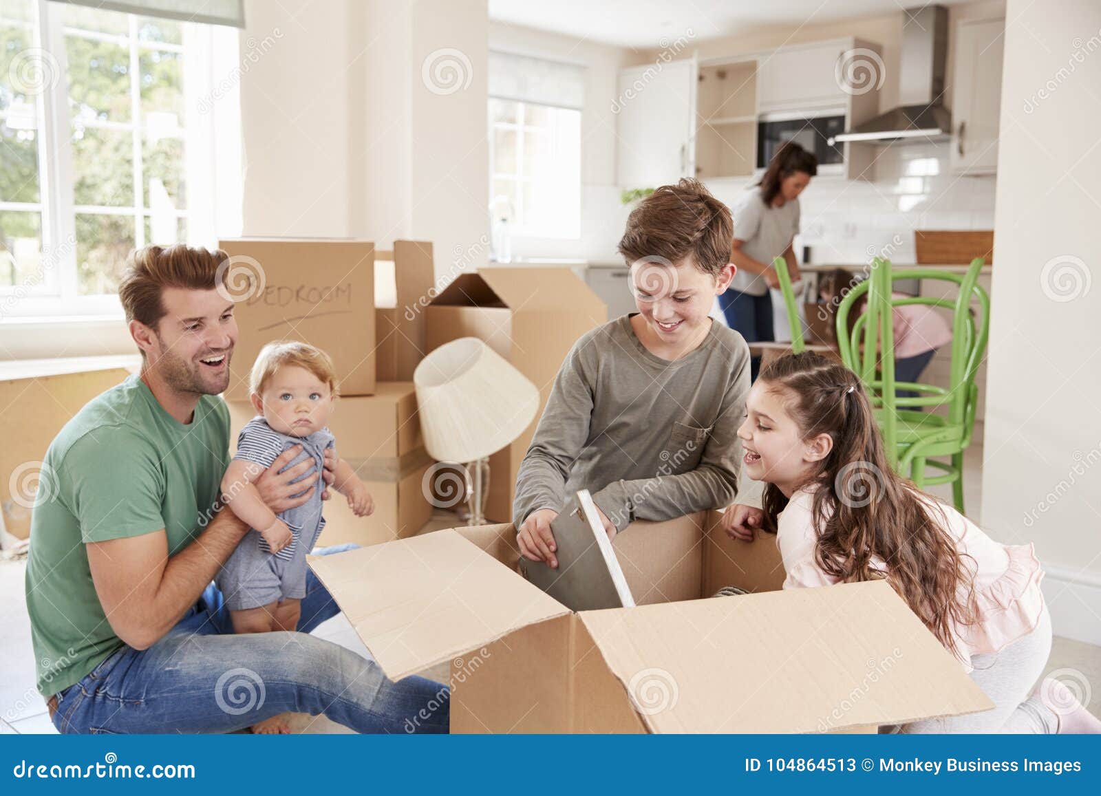 Children Helping Parents To Unpack on Moving in Day Stock Image - Image ...