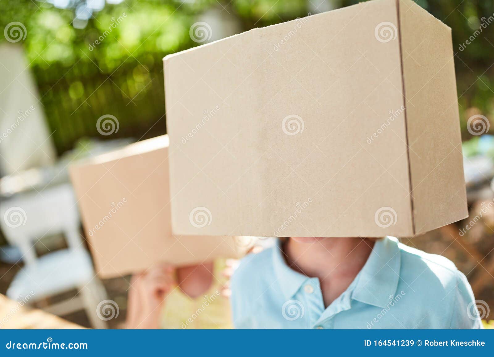 Children Hide Their Faces Under Cardboard Boxes Stock Image - Image of ...