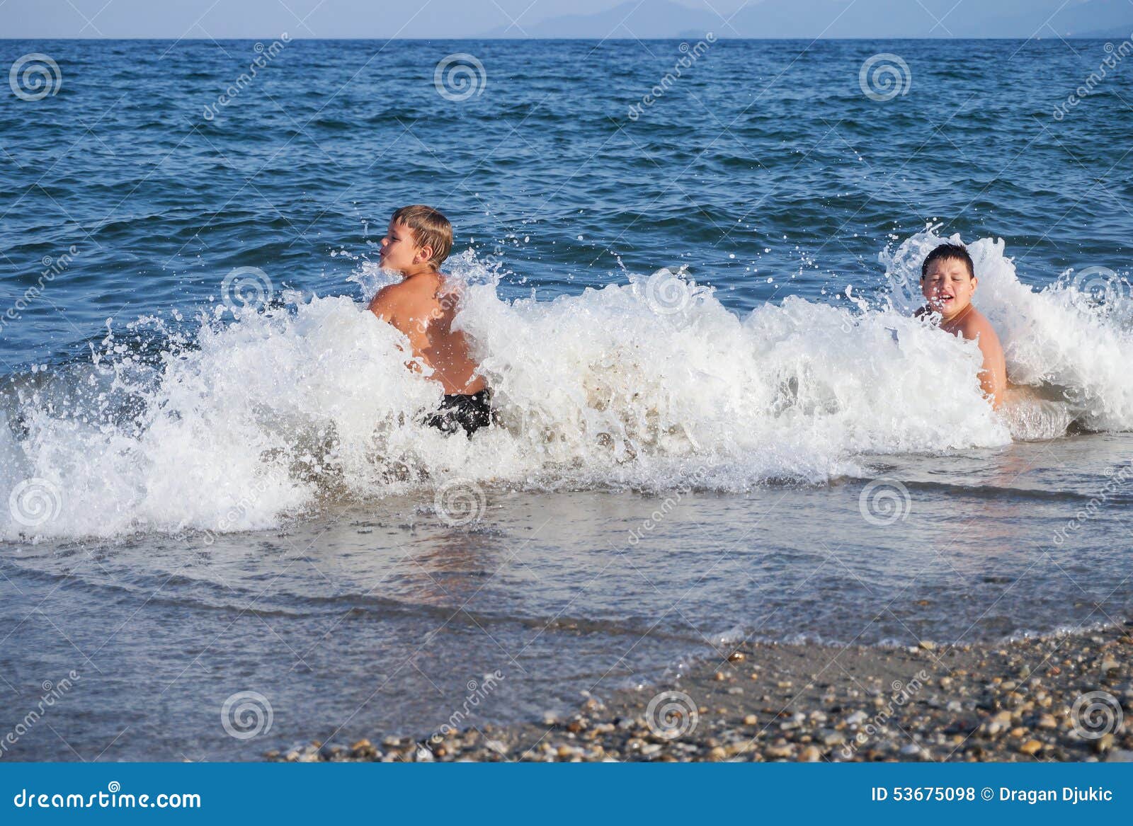 Children hit by wave stock photo. Image of beautiful - 53675098