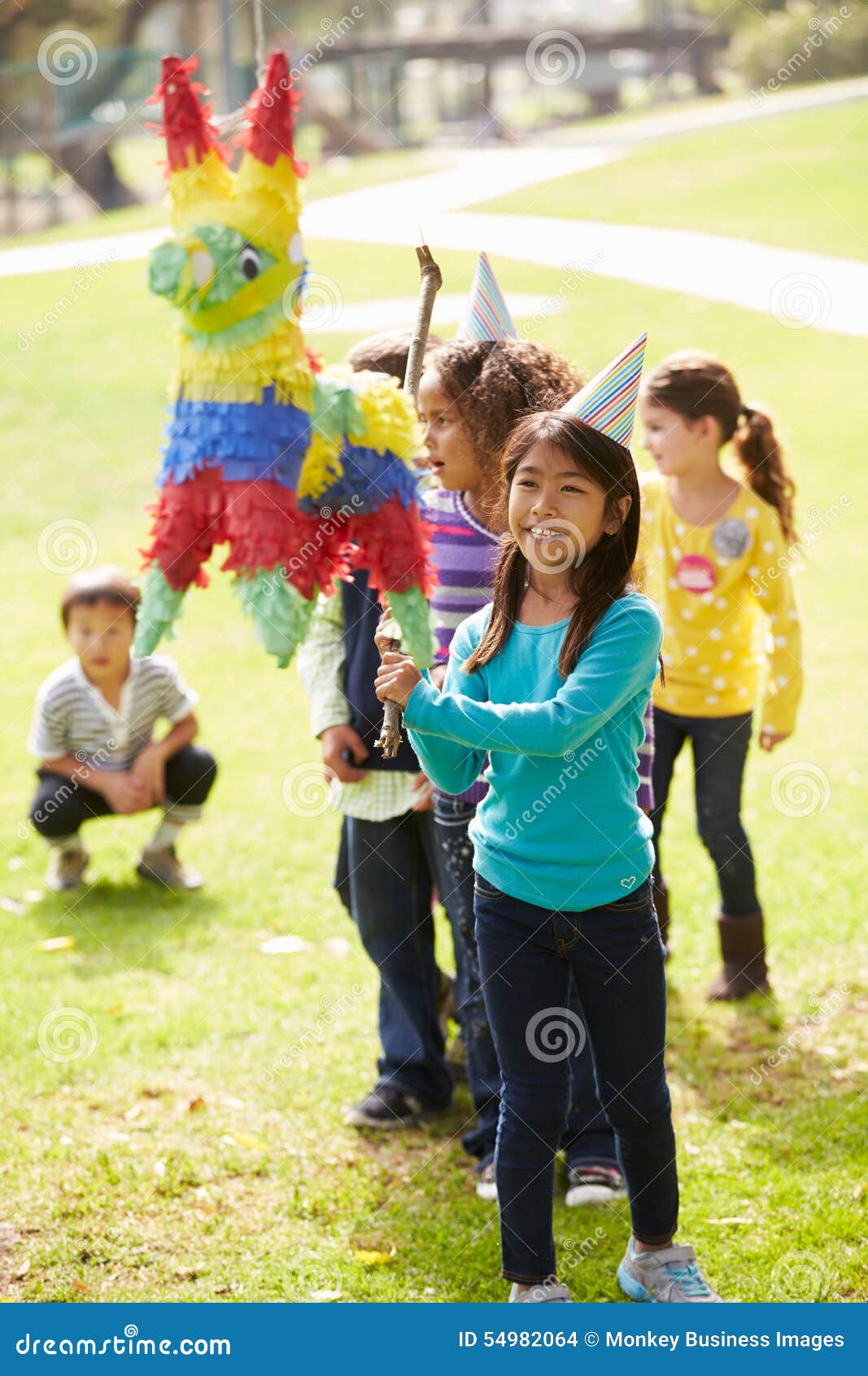 Children Hitting Pinata at Birthday Party Stock Photo - Image of people ...
