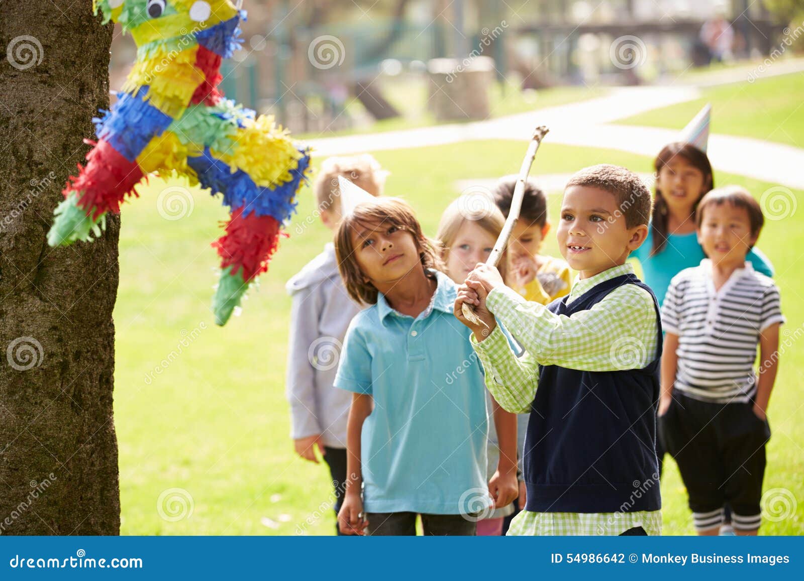 Children Hitting Pinata at Birthday Party Stock Photo - Image of ...