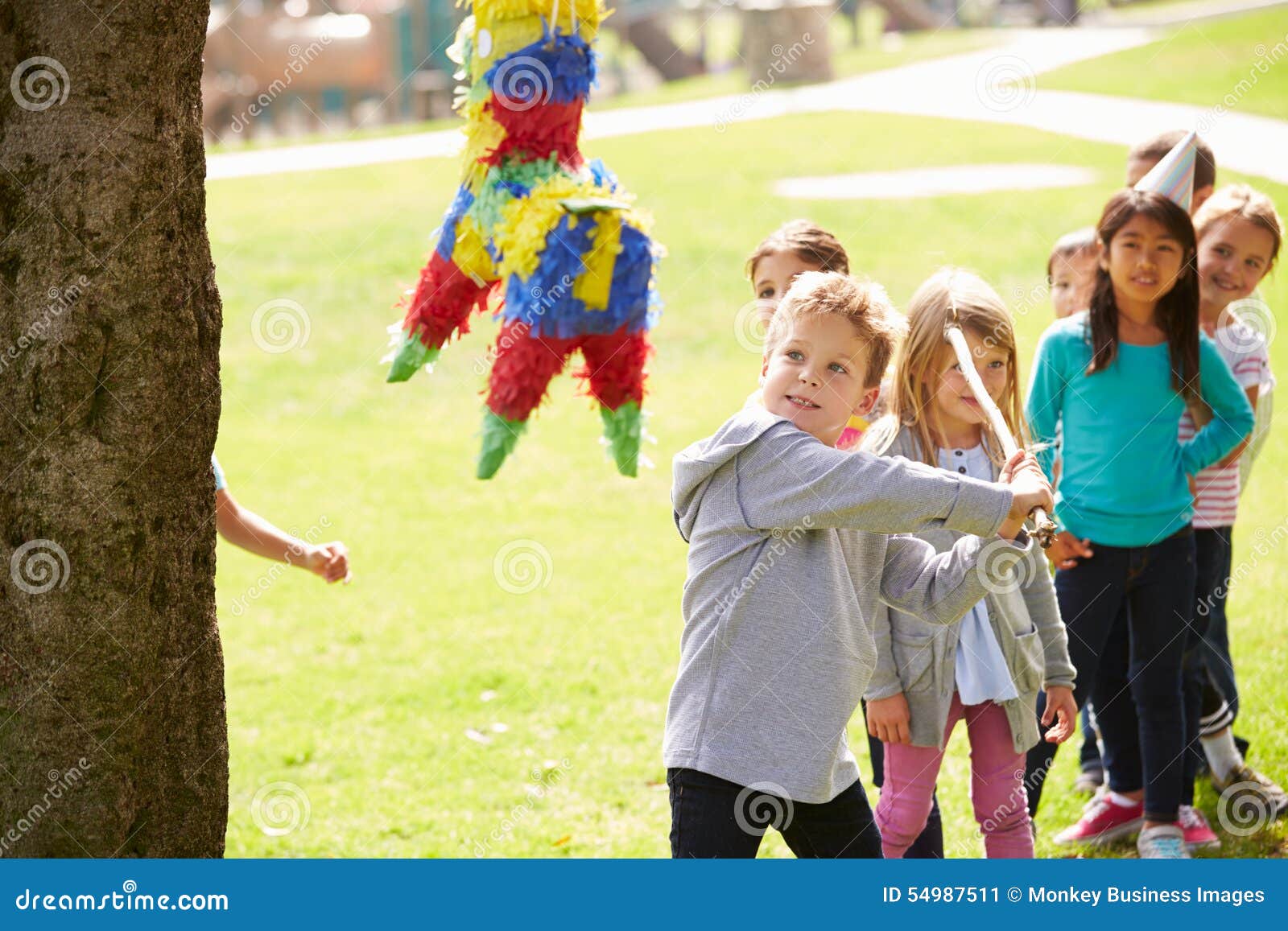 Children Hitting Pinata At Birthday Party Royalty-Free Stock ...
