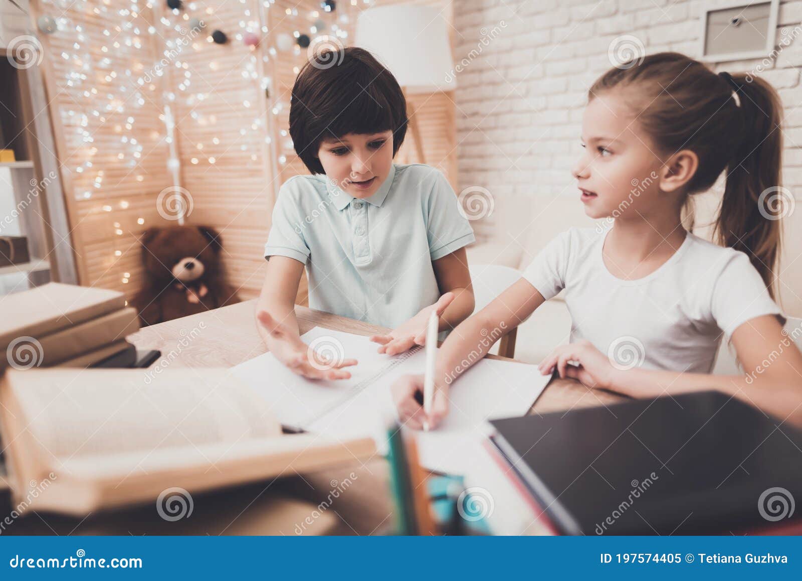 Brother Helps Sister Do Homework at Table. Stock Image - Image of ...