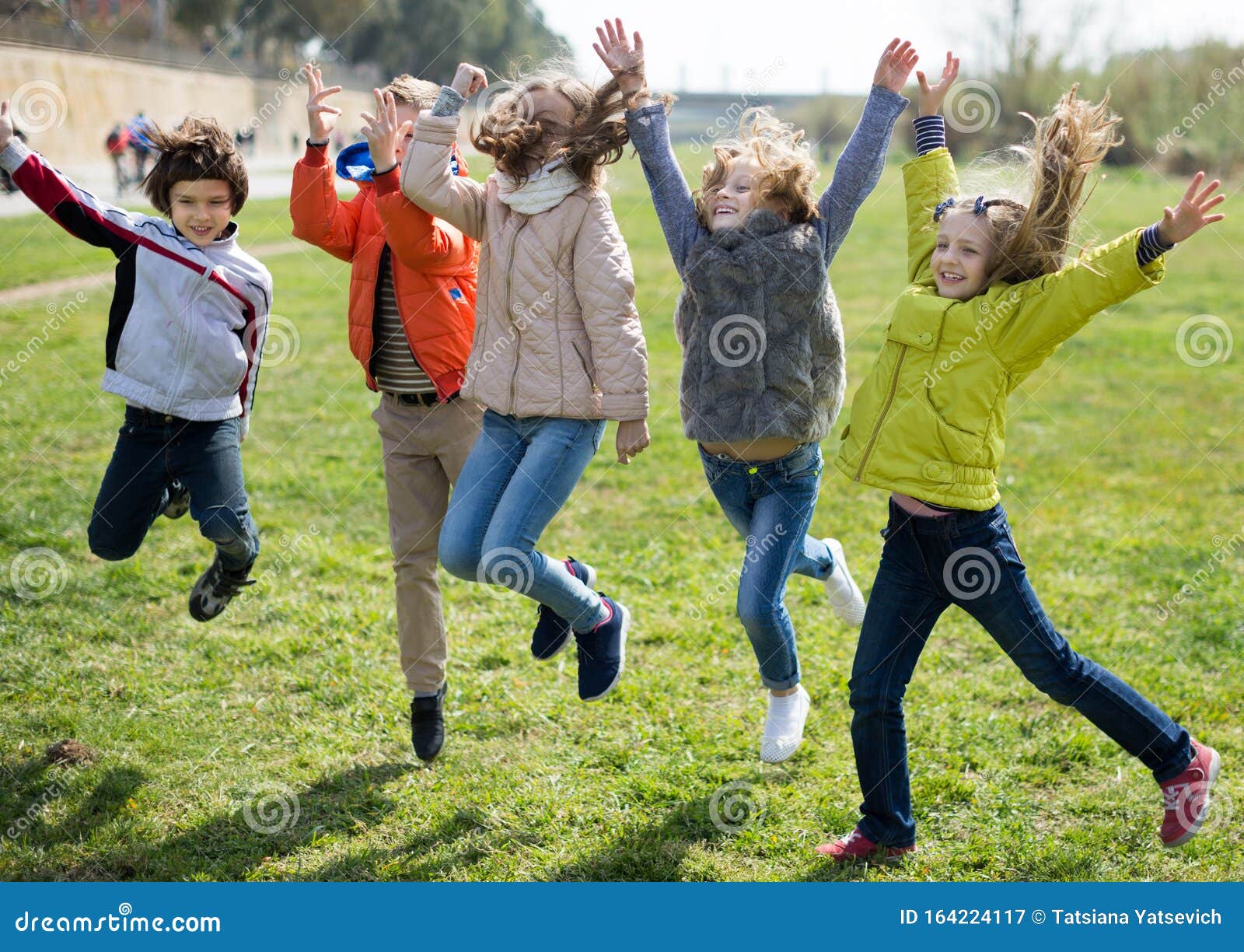 Children Jump Up on Lawn in Park Stock Image - Image of lifestyles ...