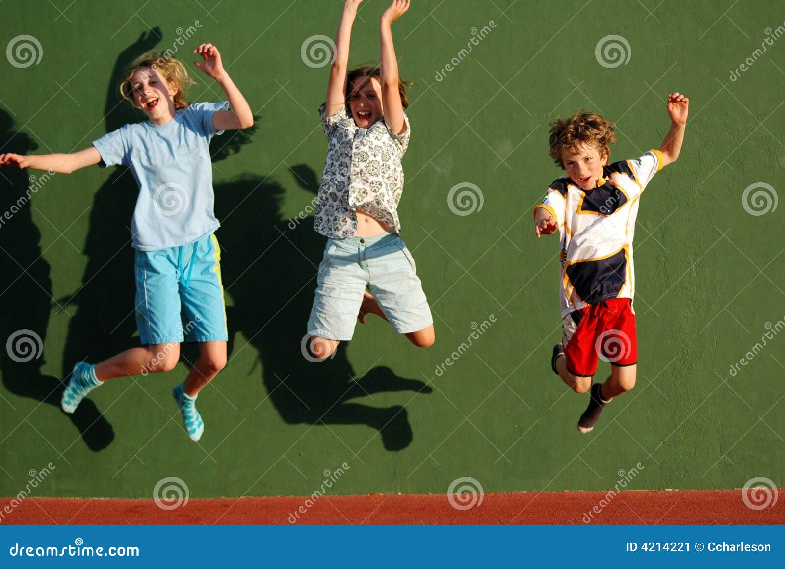 Children jumping stock image. Image of casual, heat, carefree - 4214221