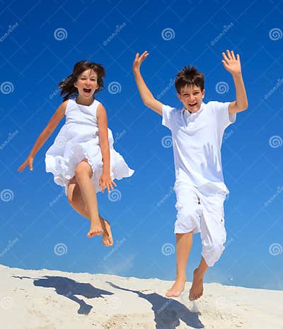 Children jumping on beach stock image. Image of leisure - 13684243