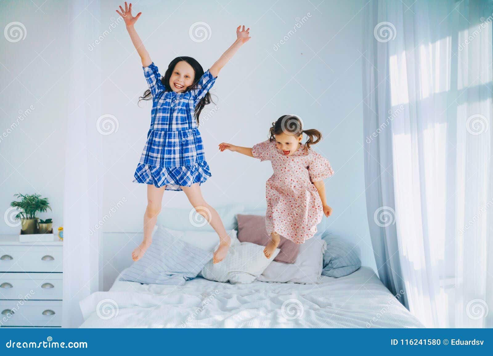 The children are jumping. stock photo. Image of bedroom - 116241580