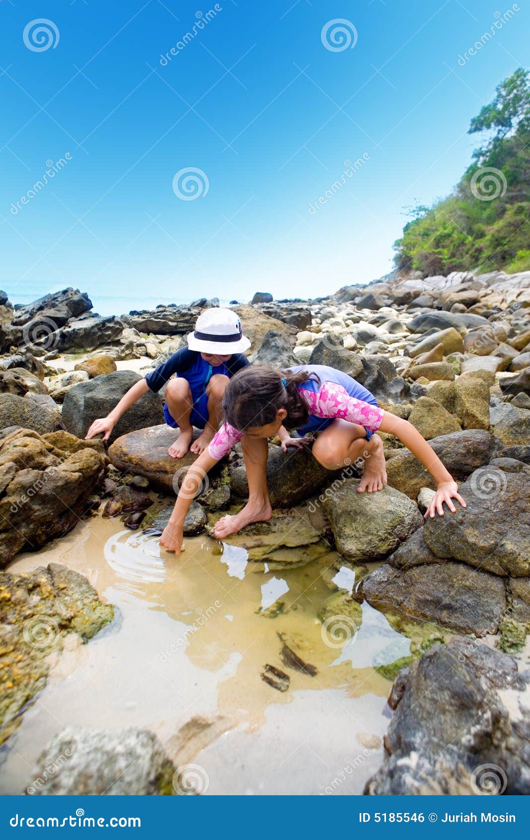 Children Looking for Little Creatures in the Rockp Stock Photo - Image ...