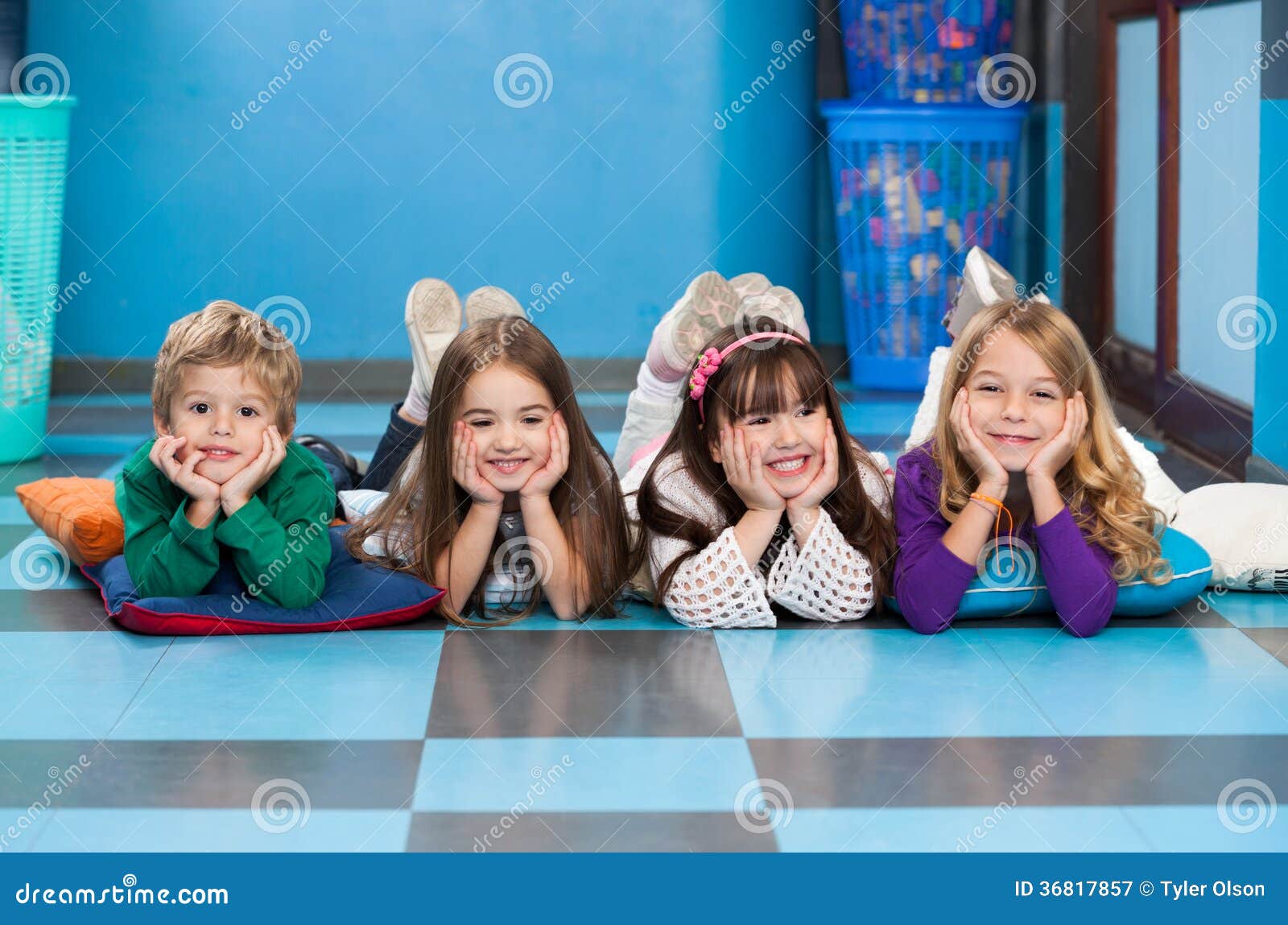 Children Lying in a Row on Floor in Classroom Stock Image - Image of ...