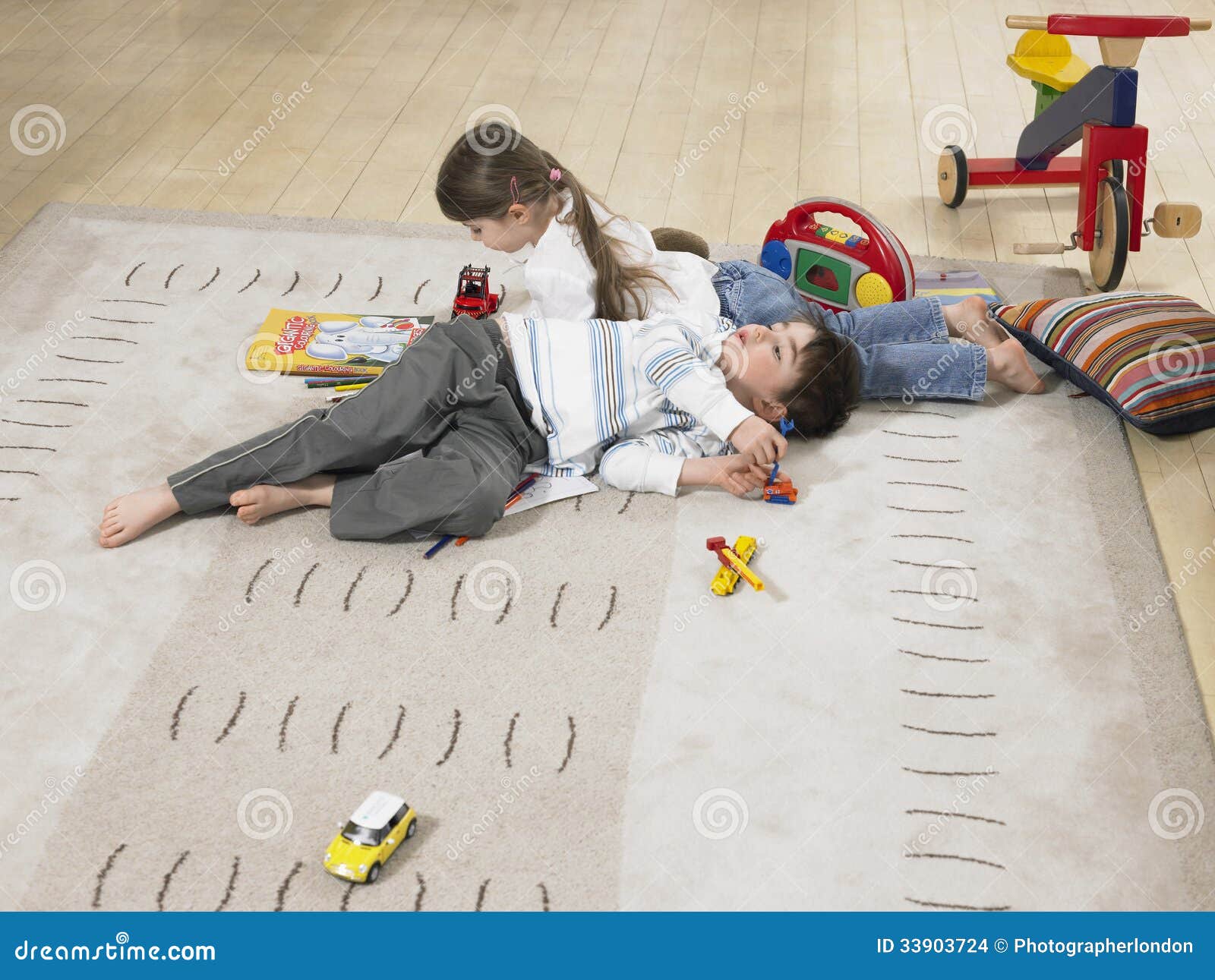 Children Lying on Rug at Home Stock Photo - Image of coloring ...