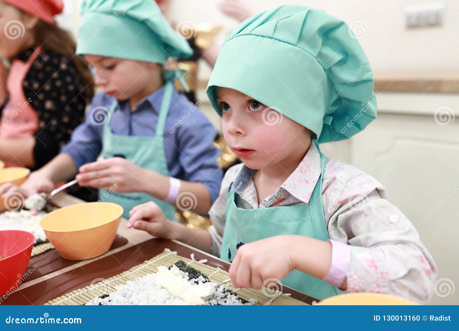 Children making sushi stock photo. Image of cookery - 130013160