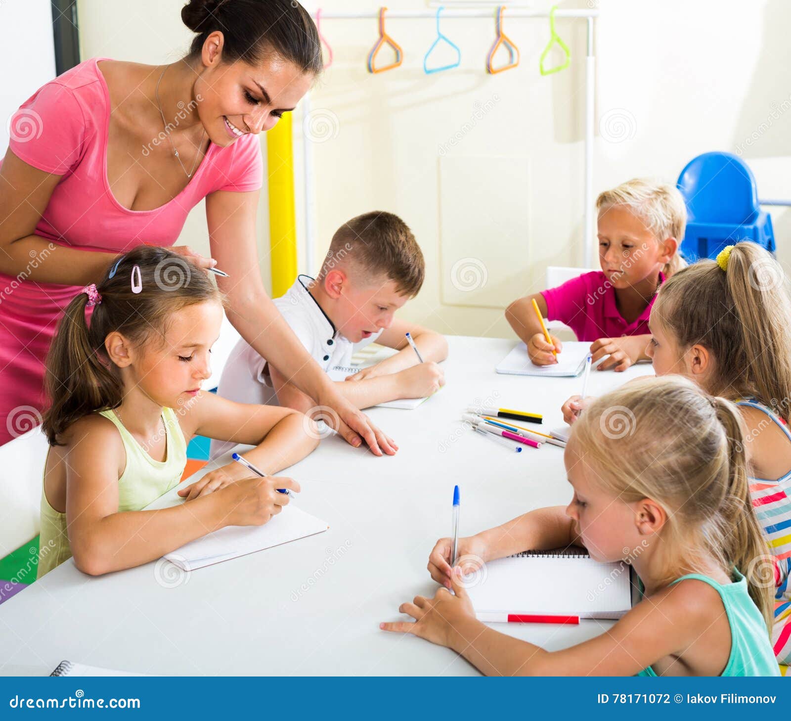 Children Making Writing Exercises with Help of Teacher in Class Stock ...