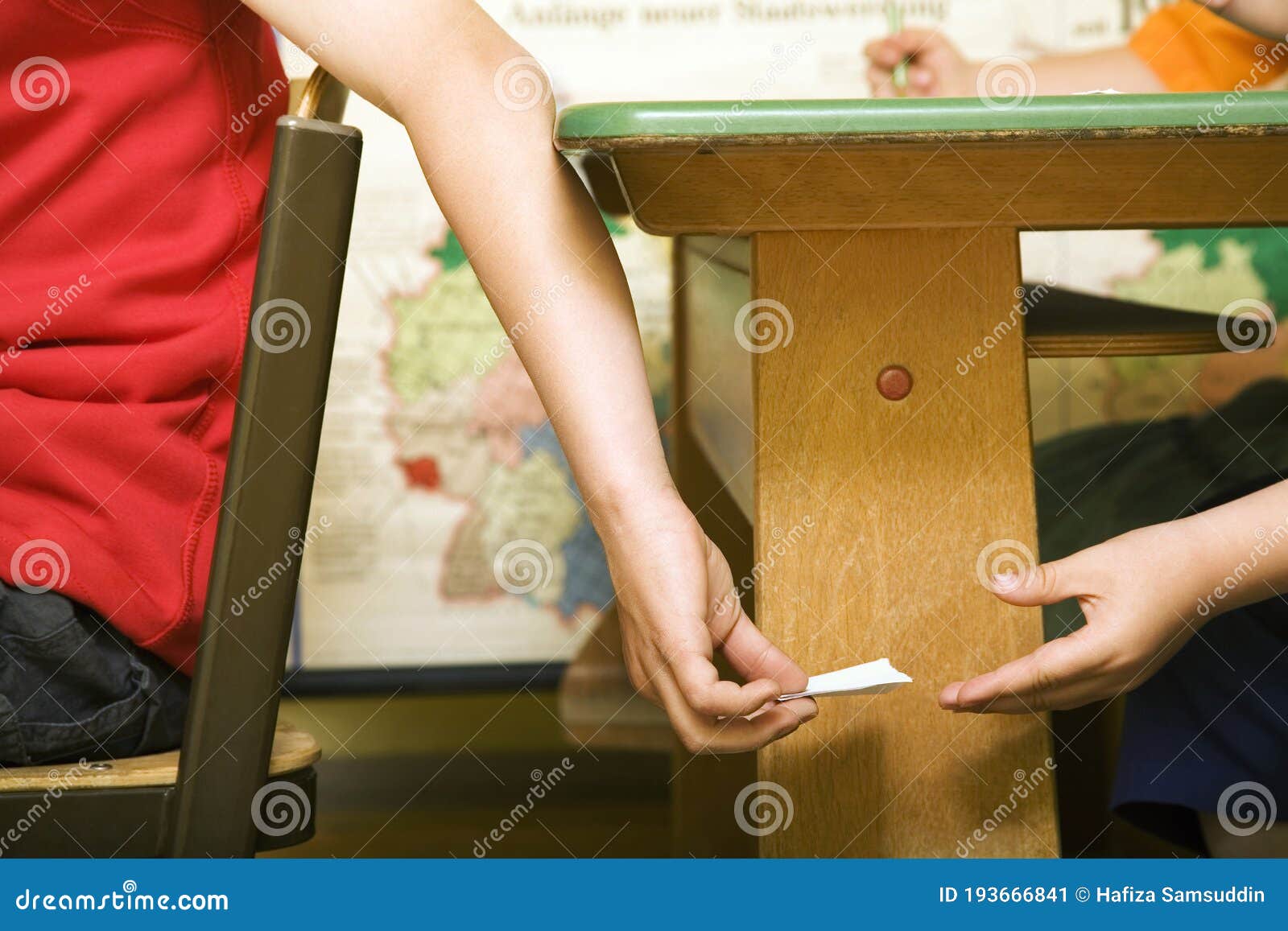 Children Passing Note Under the Table. Conceptual Image Shot Stock ...