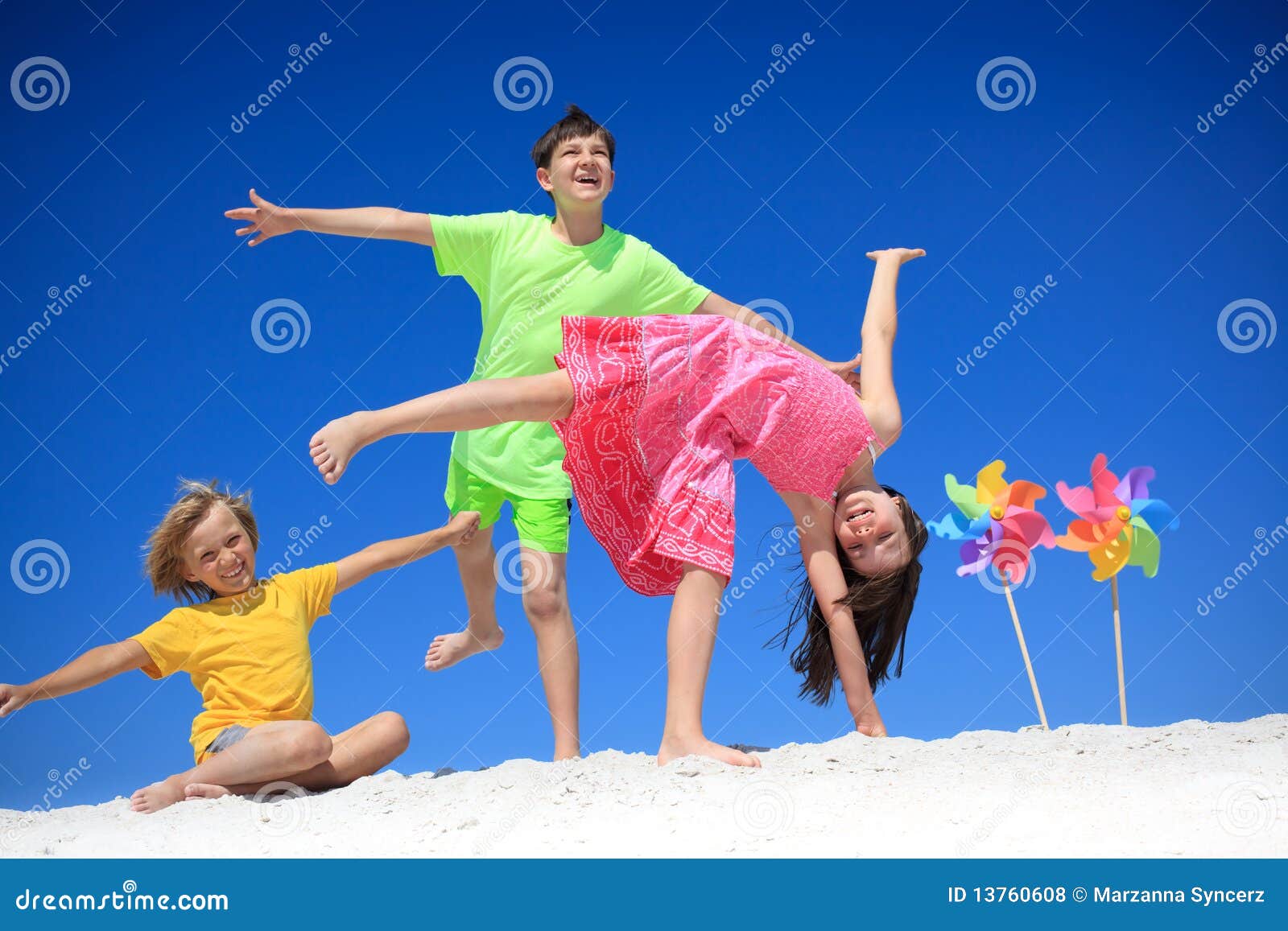 Children with Pinwheels on Beach Stock Photo - Image of pinwheels, arms ...