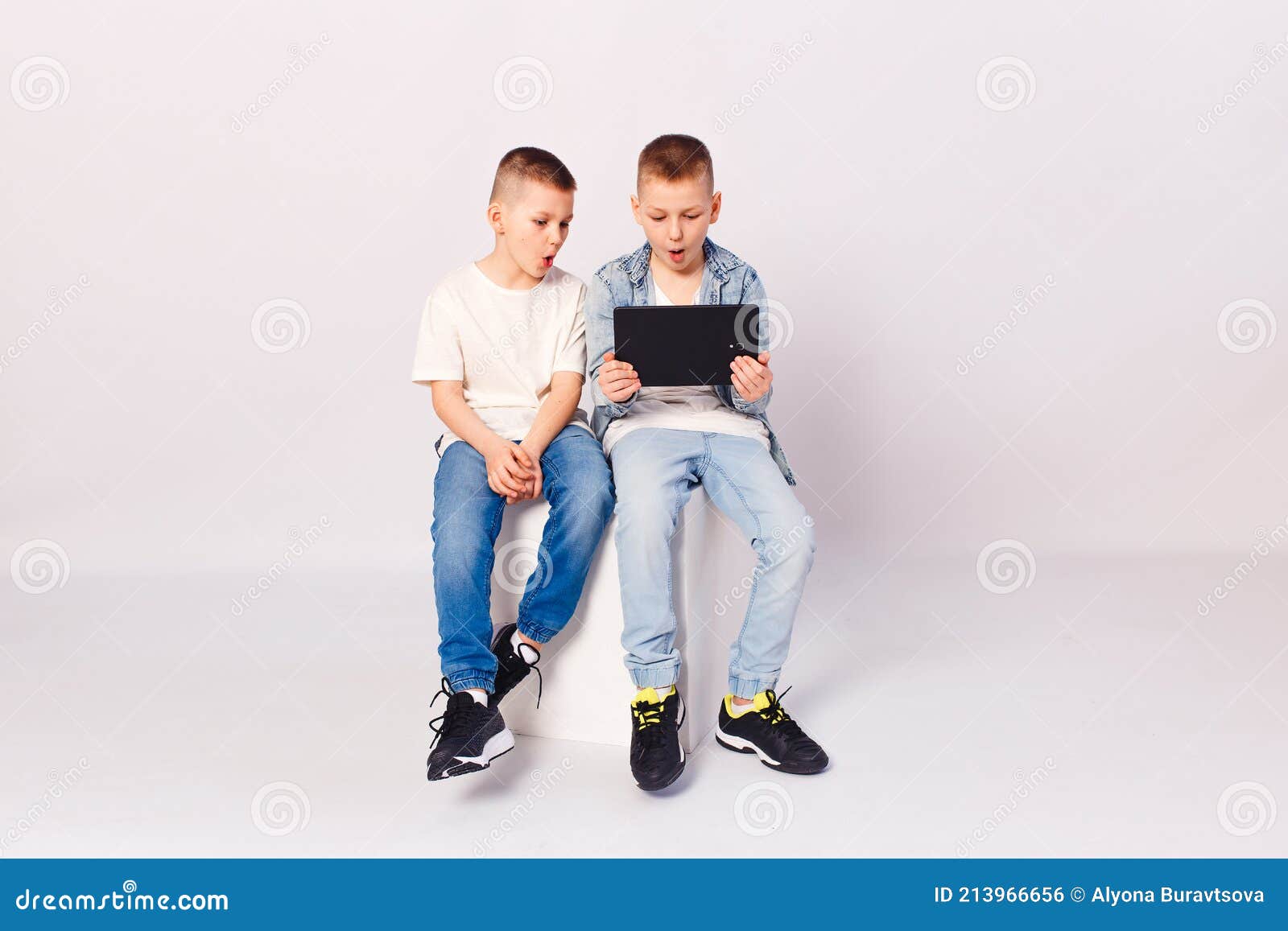Children Play Games on Tablet. Children Hold a Tablet on a White ...