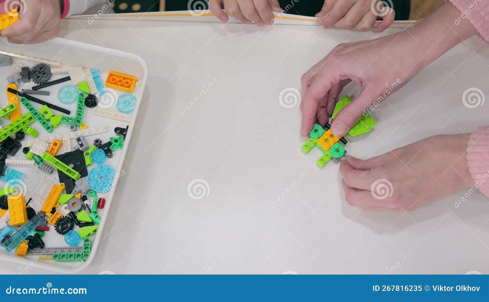 Children Play with Lego and Create Programmable Robots. Close-up of ...