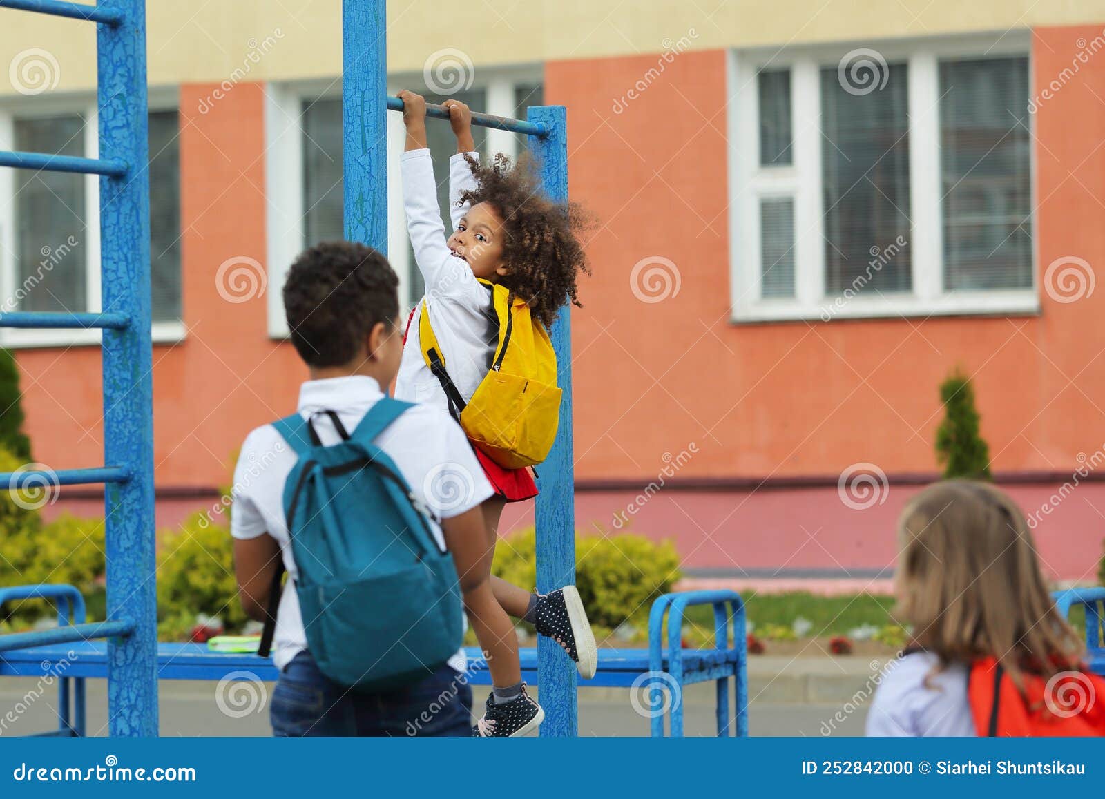 Children Play on the Playground with Backpacks, after School Stock ...